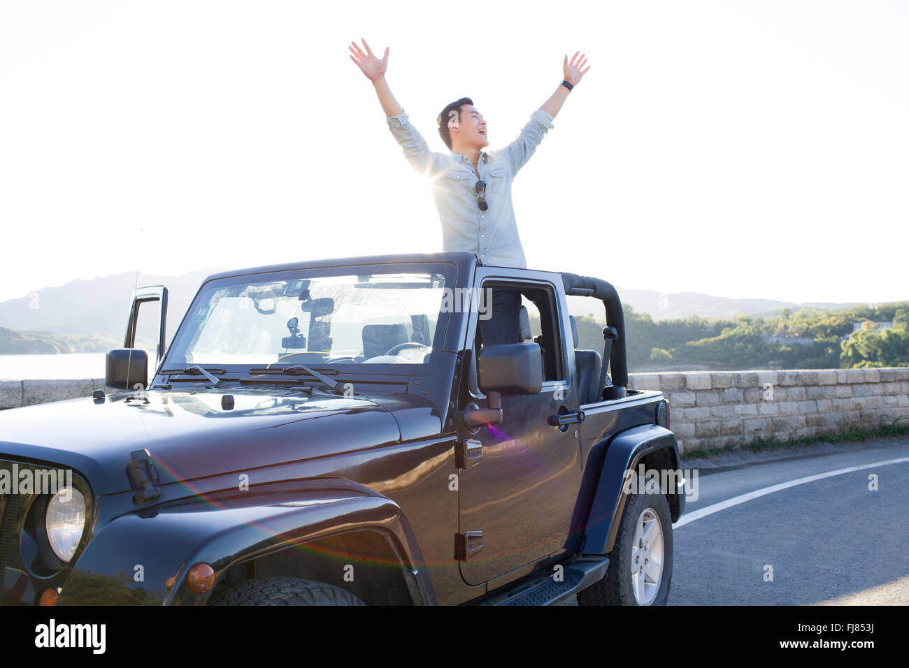 Young Chinese man and jeep Stock Photo - Alamy
