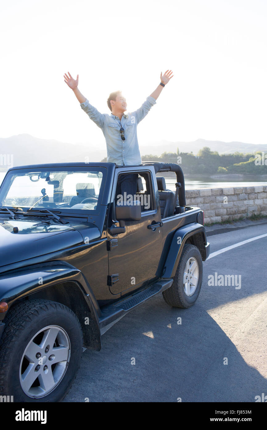 Young Chinese man and jeep Stock Photo - Alamy