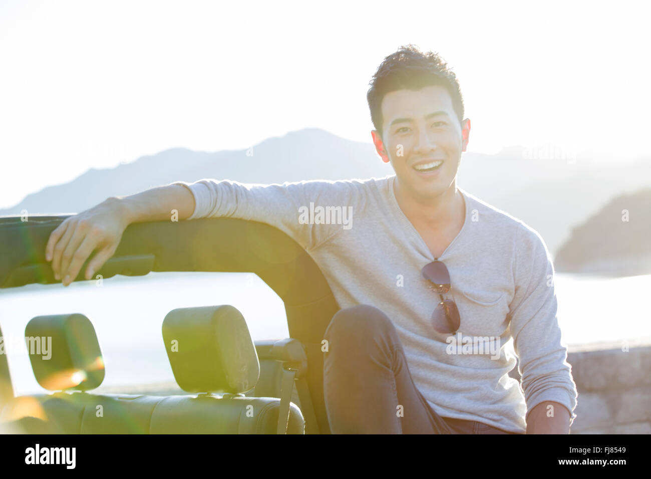 Young Chinese man and jeep Stock Photo - Alamy