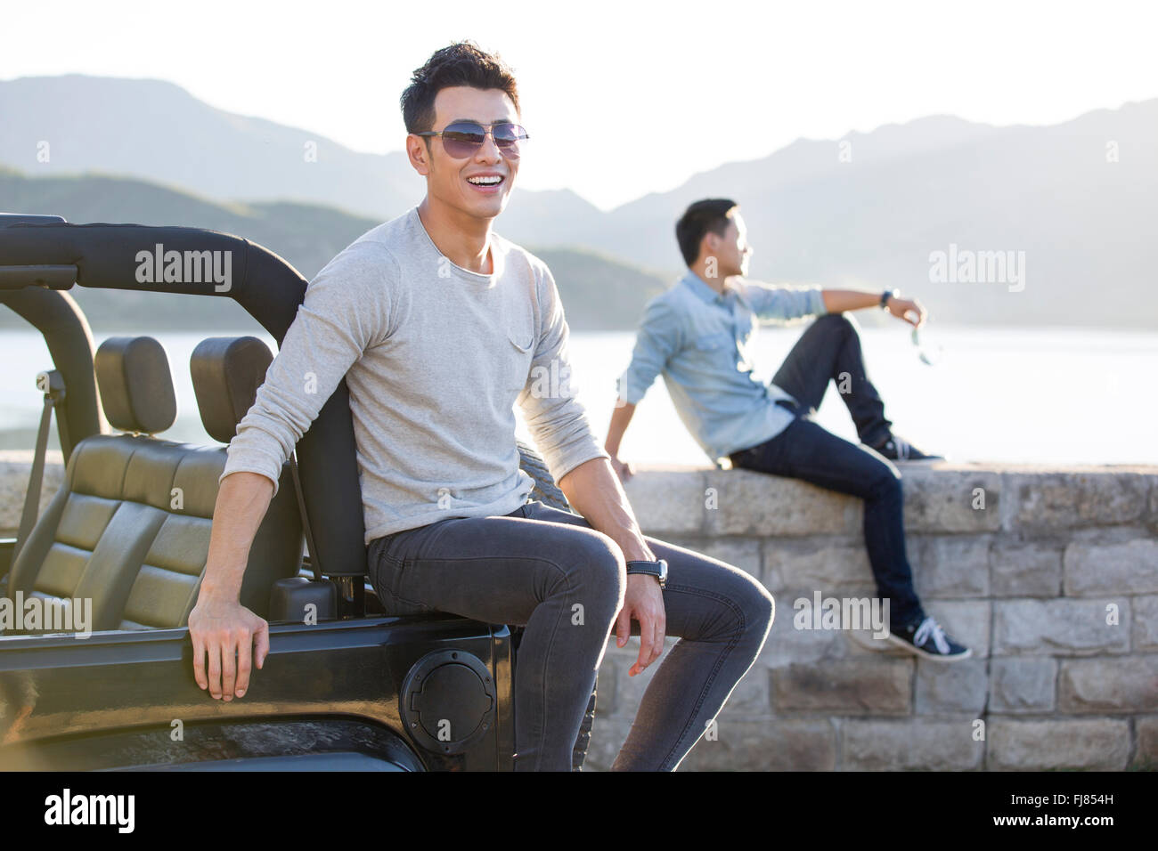 Happy young Chinese men and jeep Stock Photo - Alamy