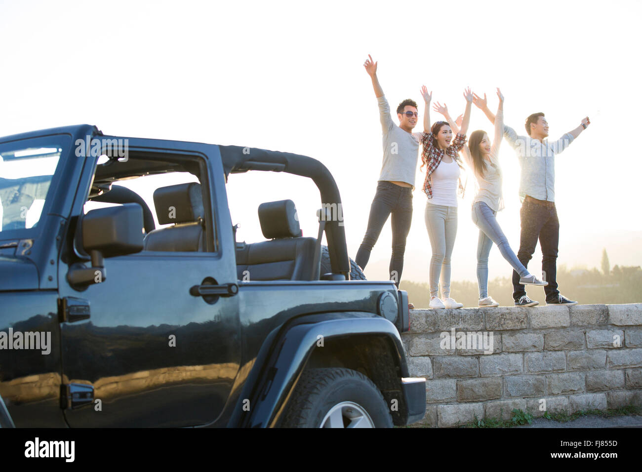 Happy Chinese friends and jeep Stock Photo - Alamy