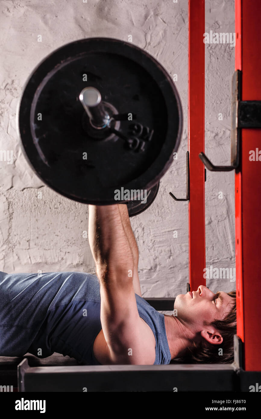 Man doing a bench press with a barbell. Photography in the profile ...