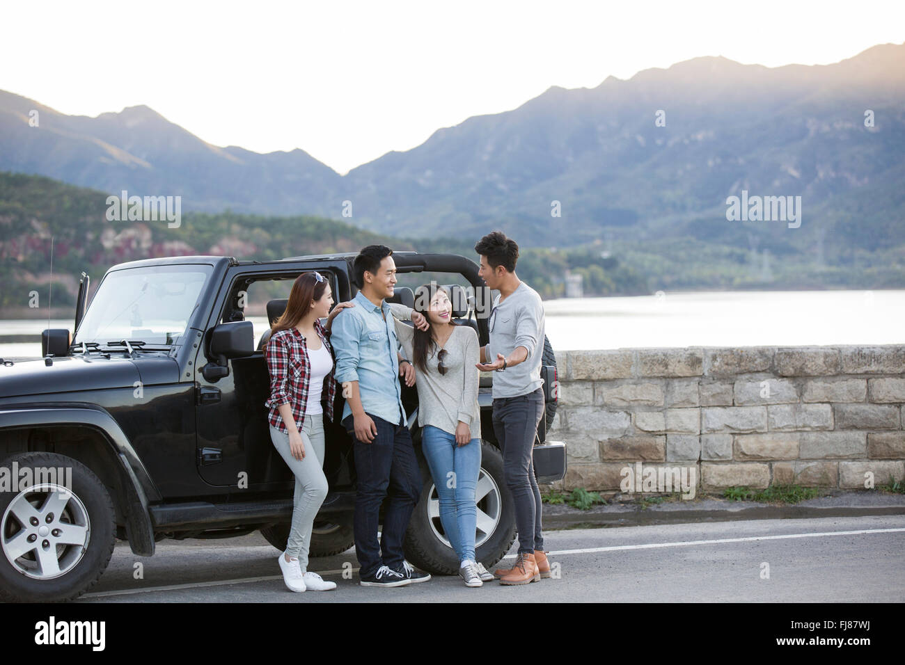Happy Chinese friends and jeep Stock Photo - Alamy
