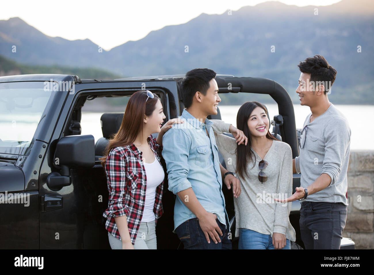 Young couple talking friends lake hi-res stock photography and images ...