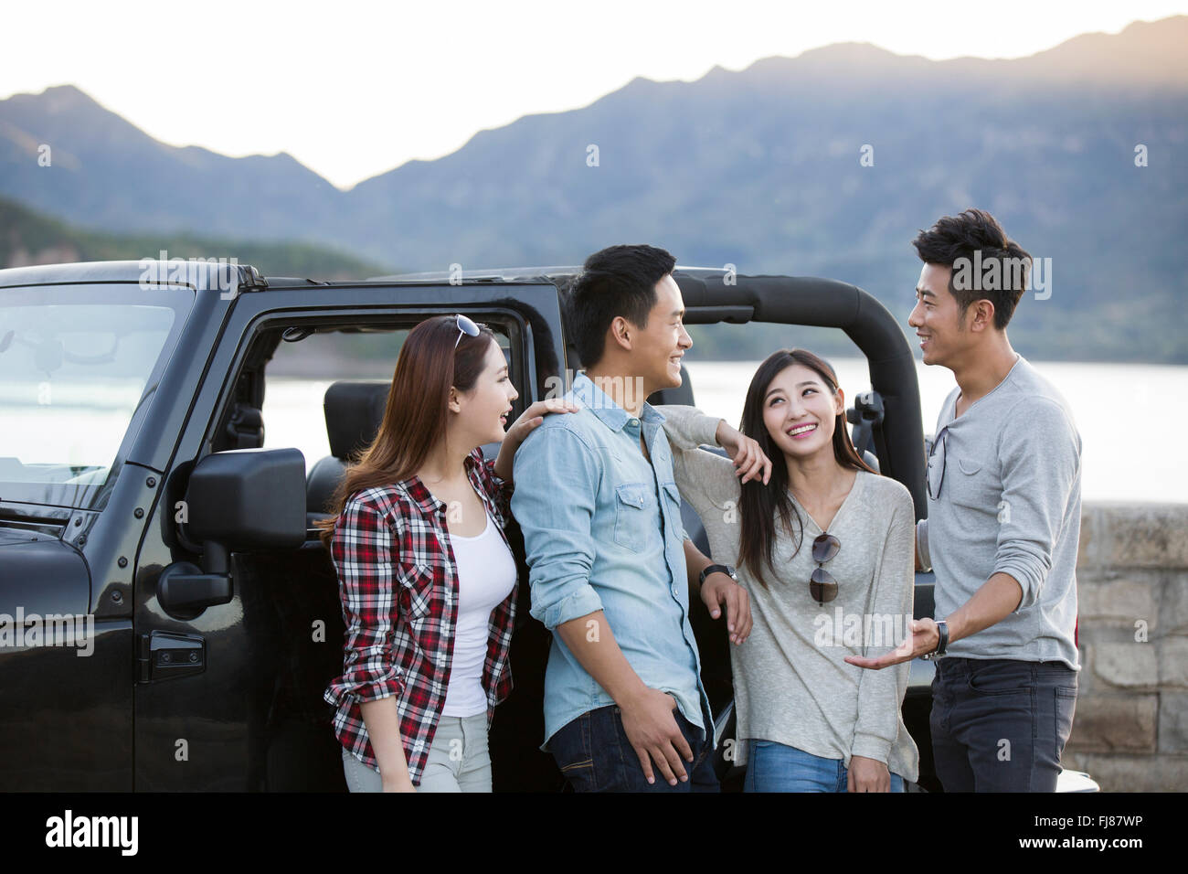 Young couple talking friends lake hi-res stock photography and images ...