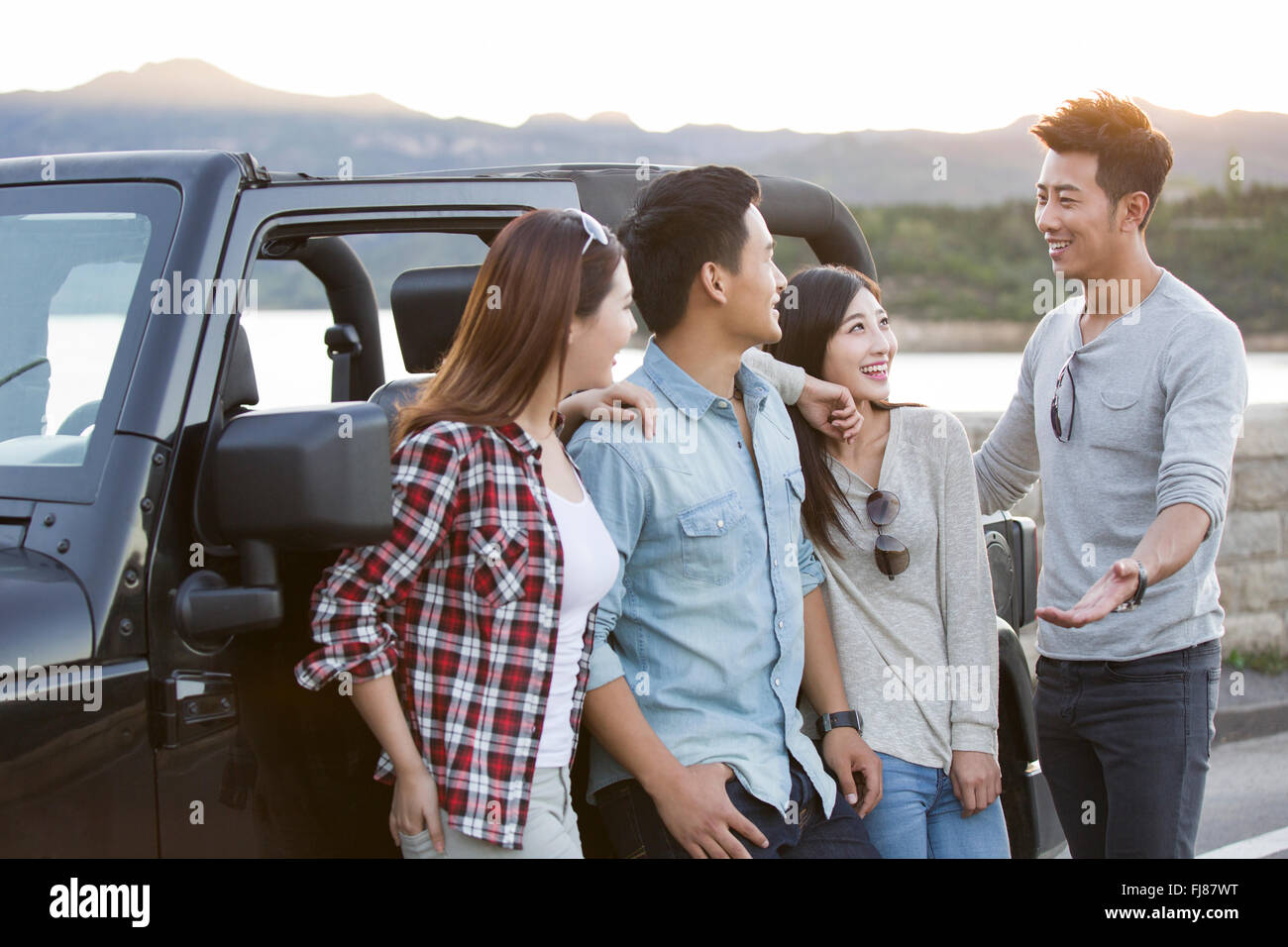 Happy Chinese friends and jeep Stock Photo - Alamy