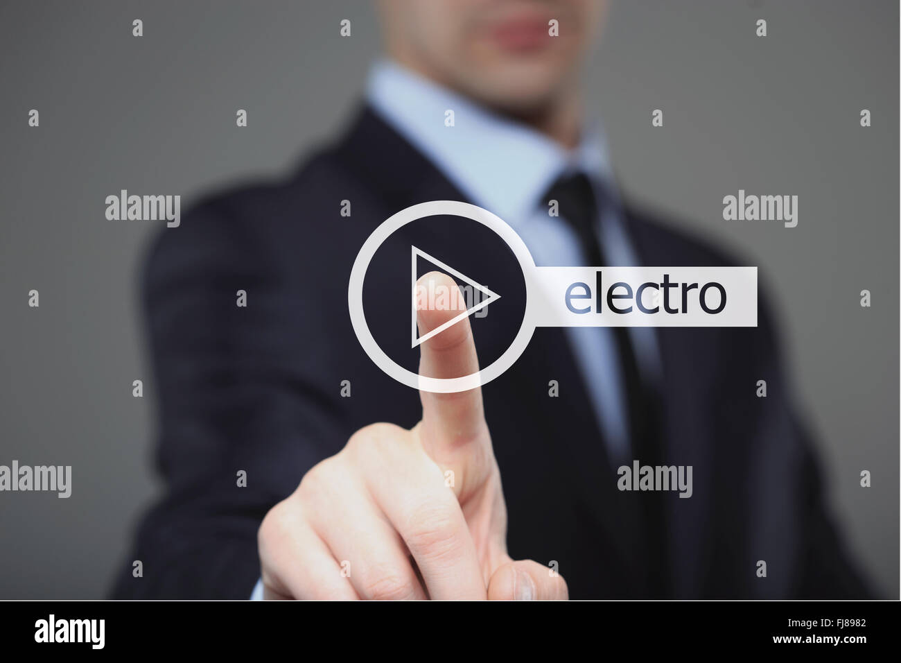 Businessman pressing play electro music button Stock Photo - Alamy