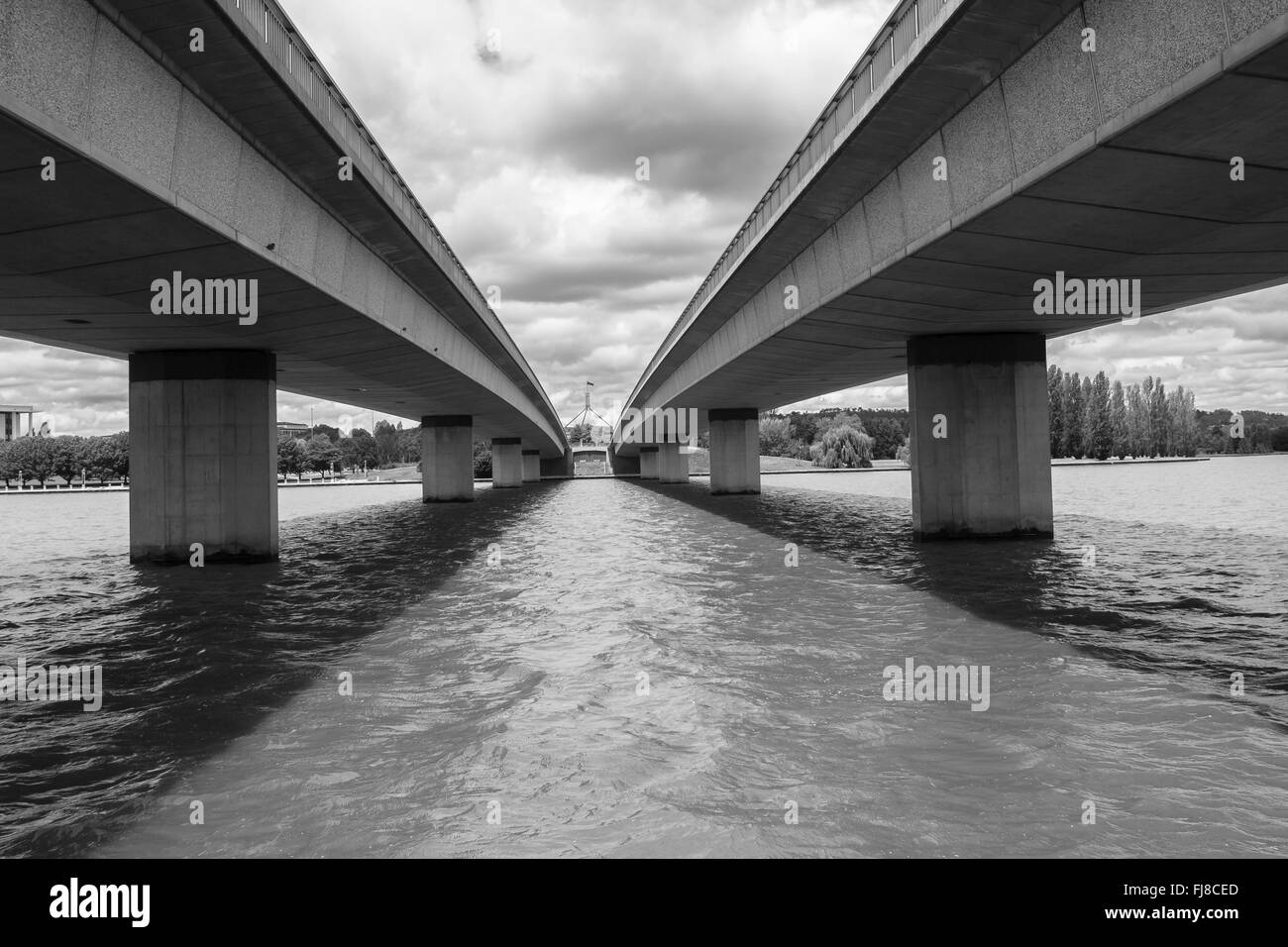 Bridges Two side by side travel crossing structures over lake water ...