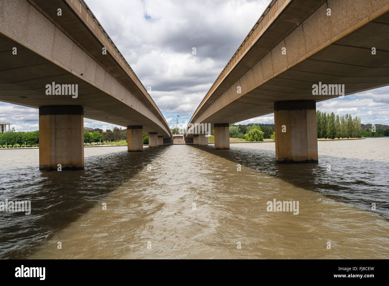 Bridges Two side by side travel crossing structures over lake water ...