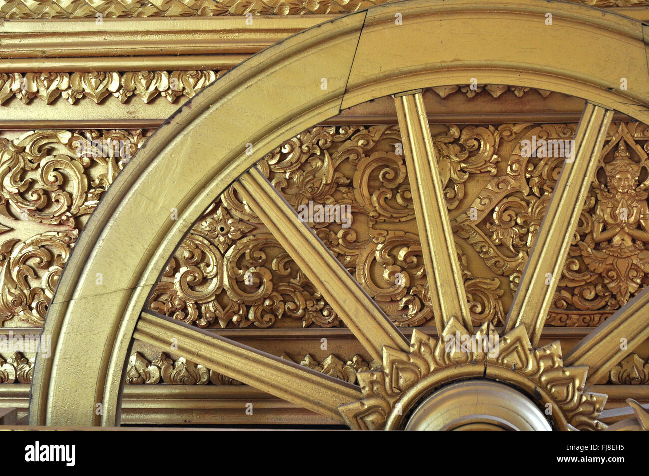 Detail : wheel of an ornate golden carriage, buddhist temple, Luang ...
