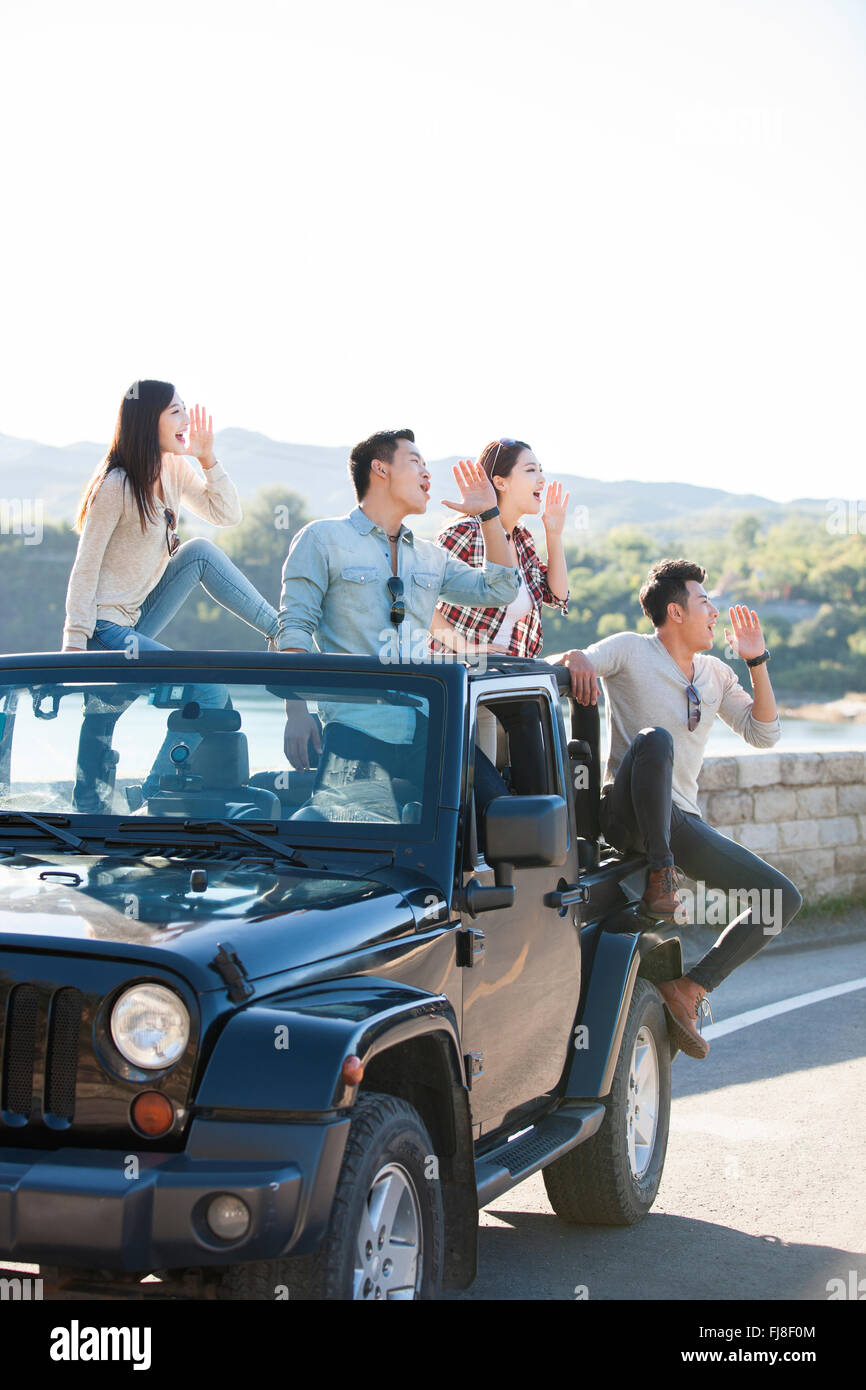 Chinese friends having fun in a jeep Stock Photo - Alamy