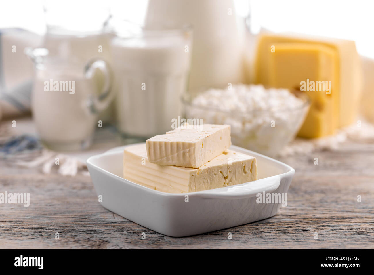 Greek feta cheese block in white plate Stock Photo - Alamy