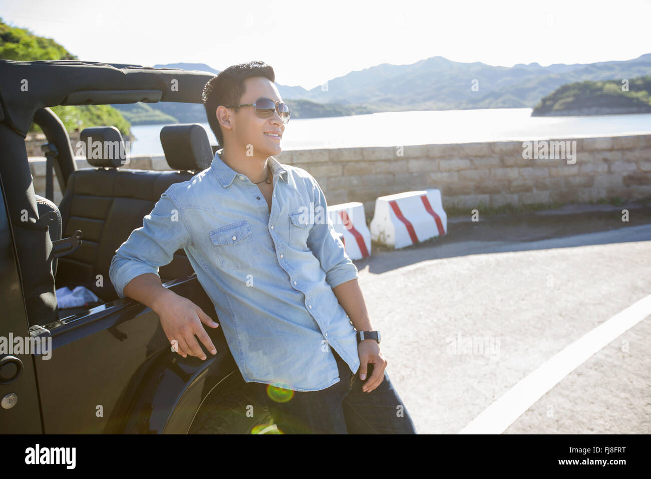 Young Chinese man and jeep Stock Photo - Alamy
