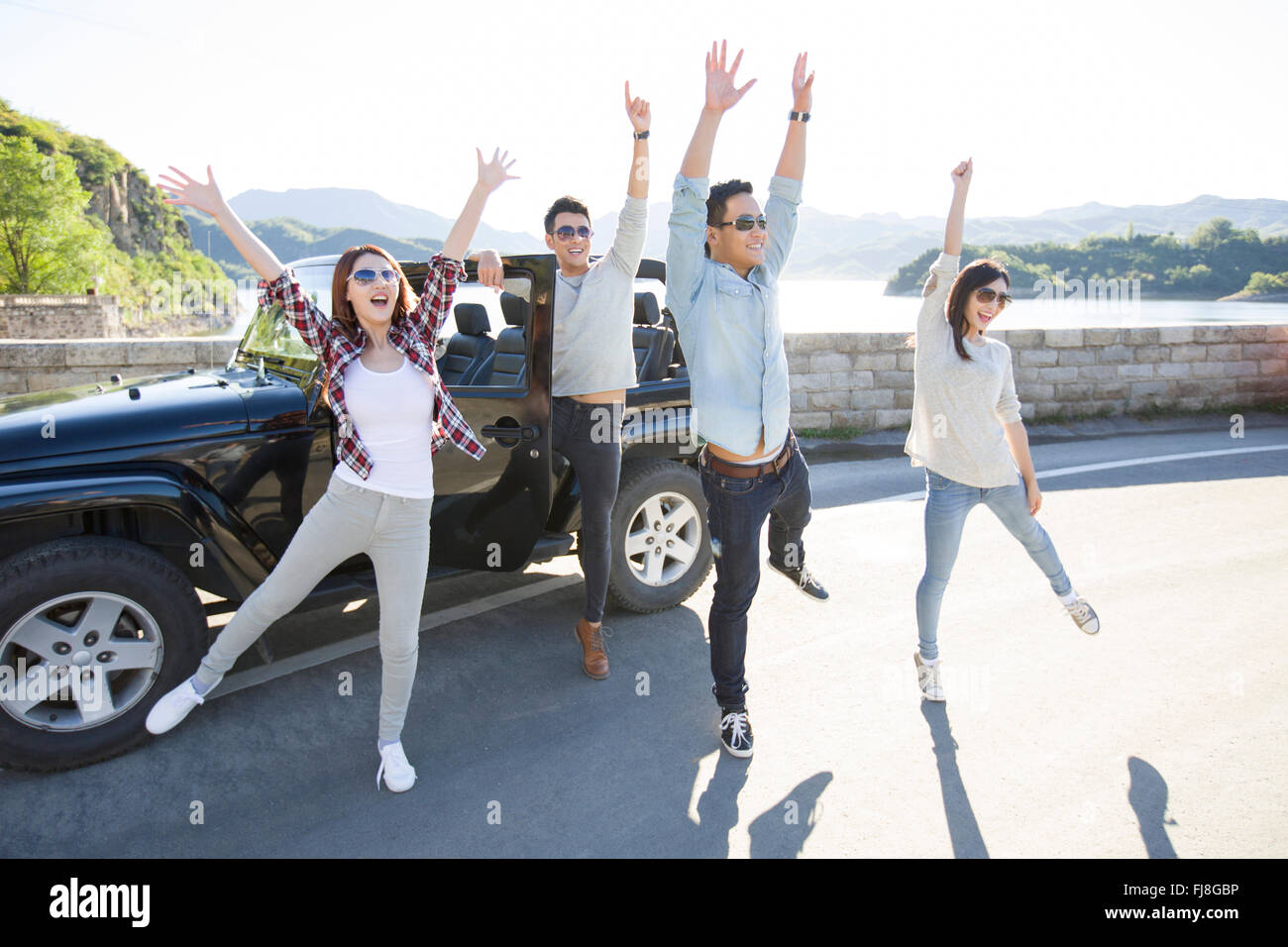 Happy Chinese friends and jeep Stock Photo - Alamy