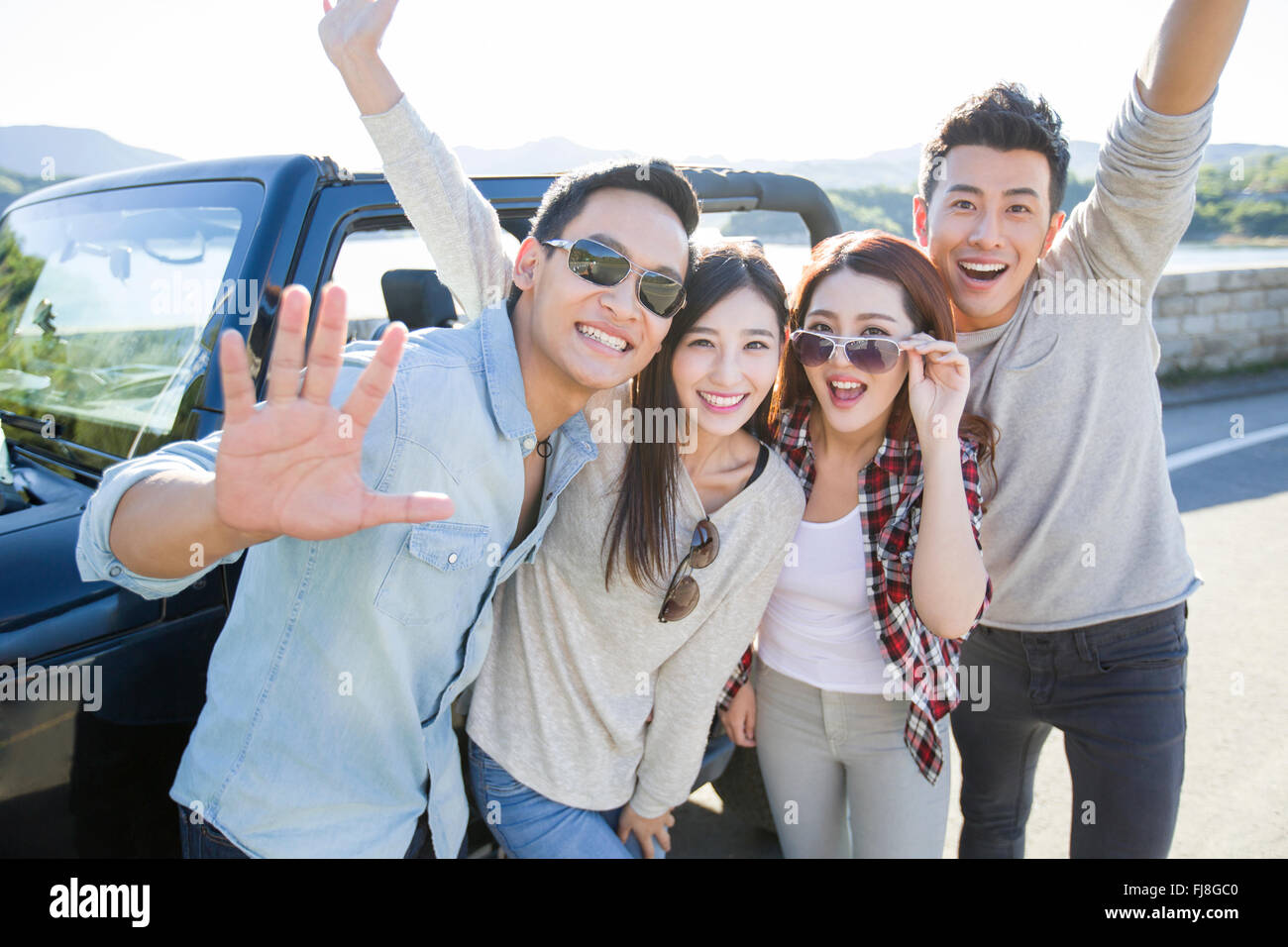 Happy Chinese friends and jeep Stock Photo - Alamy