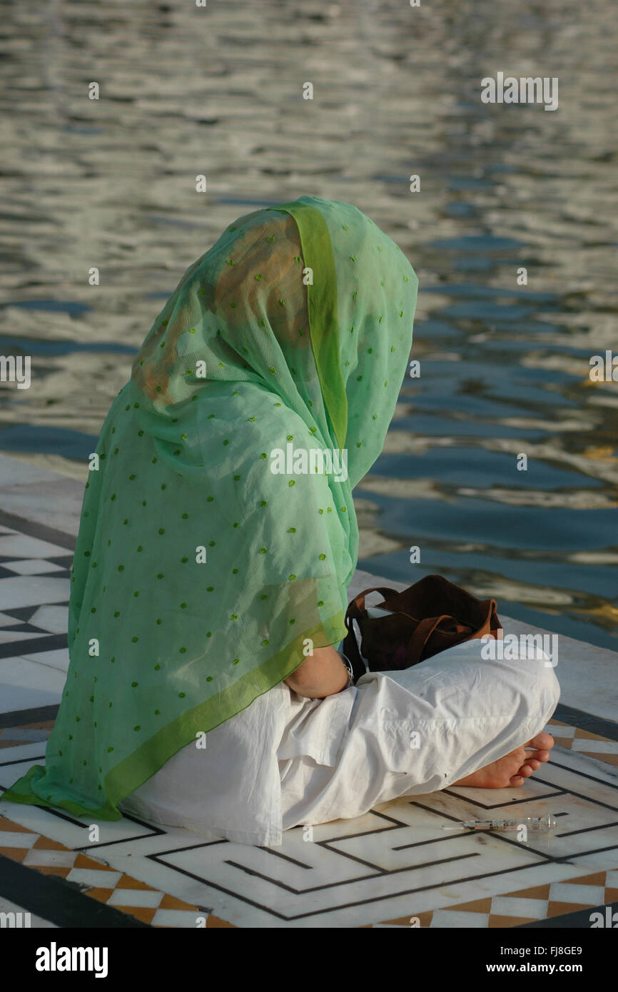 Woman Praying By The Water