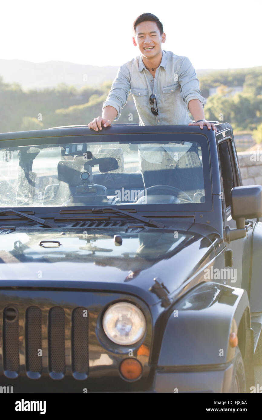 Young Chinese man and jeep Stock Photo - Alamy