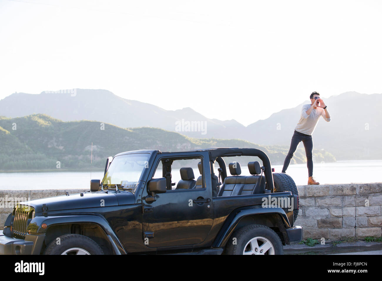 Young Chinese man and jeep Stock Photo - Alamy