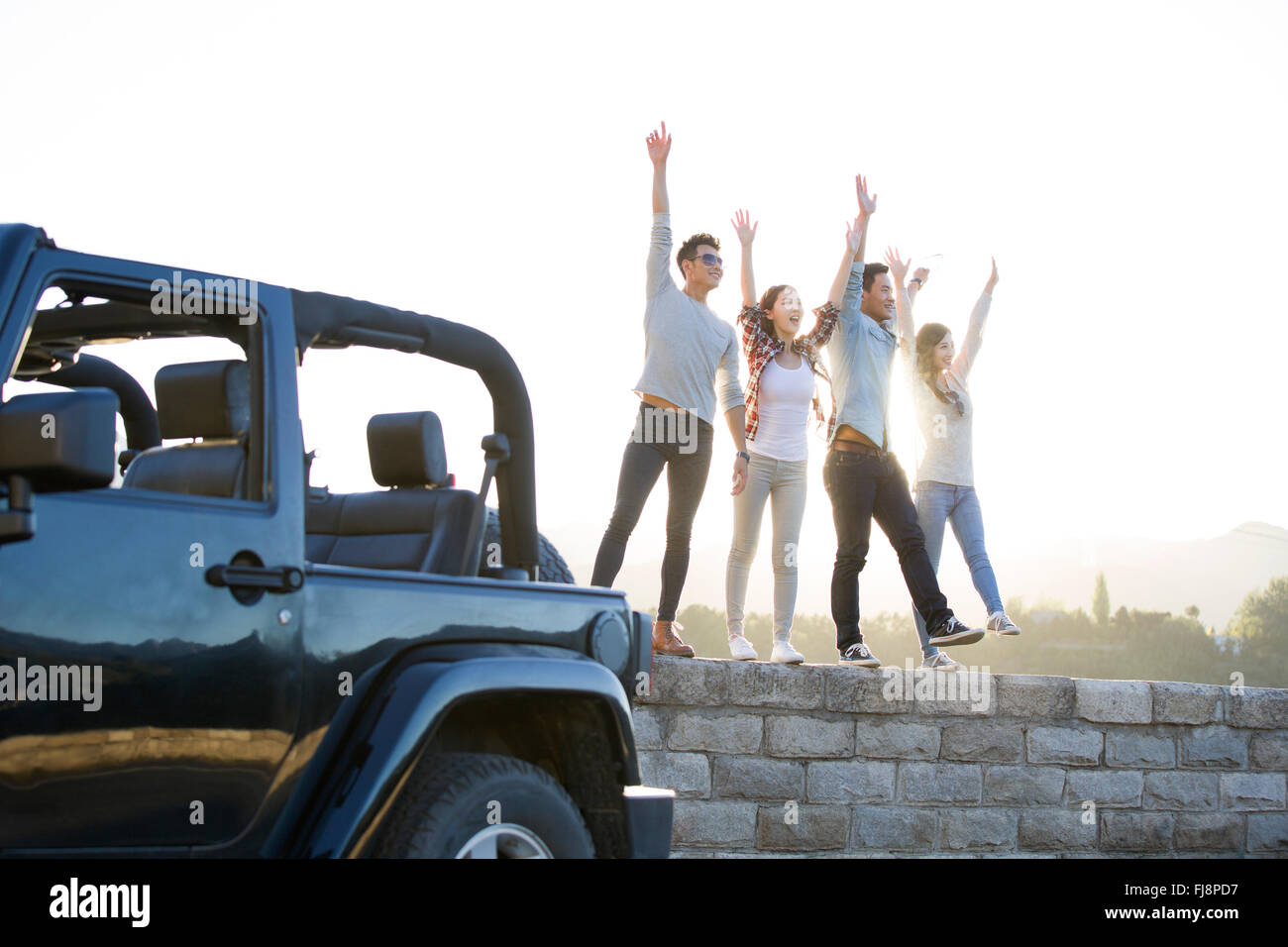 Happy Chinese friends and jeep Stock Photo - Alamy