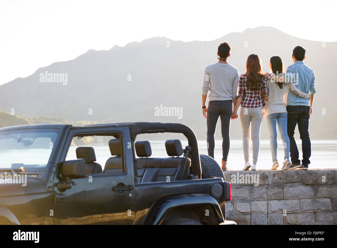 Happy Chinese friends and jeep Stock Photo - Alamy