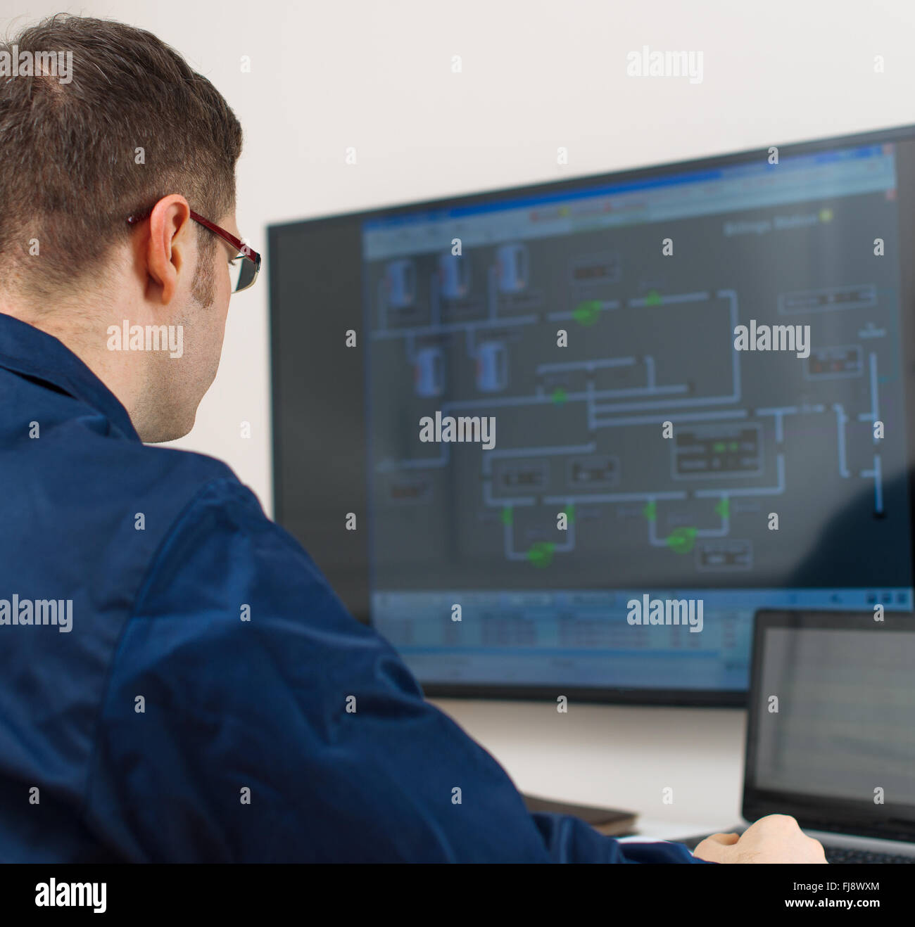 Engineer monitoring control room hi-res stock photography and images ...