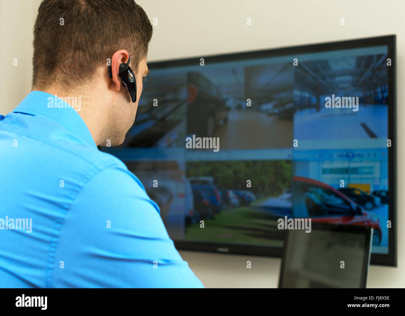 Security guard monitoring video in security room Stock Photo - Alamy