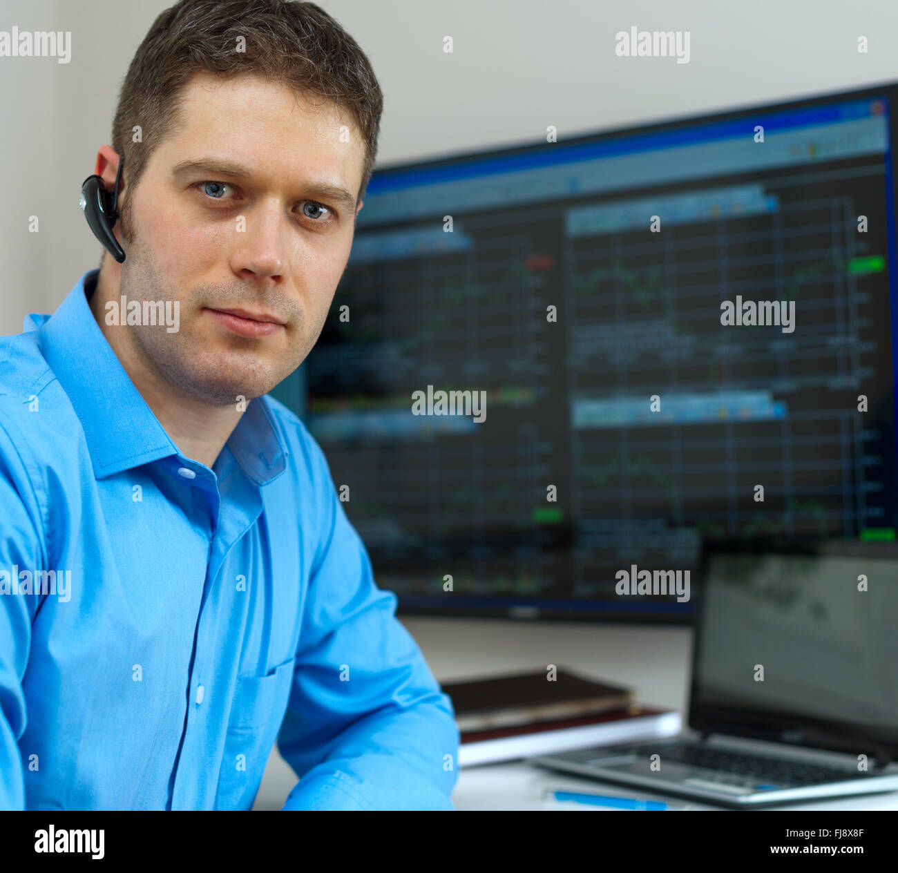 Handsome stock trader in front of computer Stock Photo - Alamy