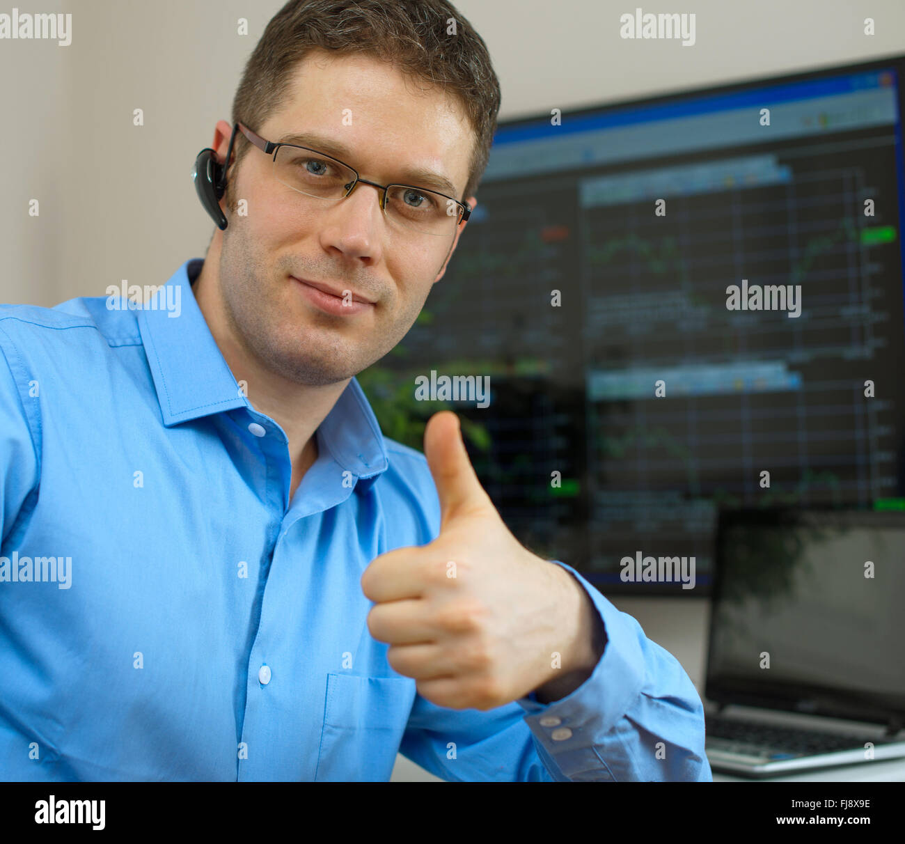 Handsome stock trader in front of computer Stock Photo - Alamy