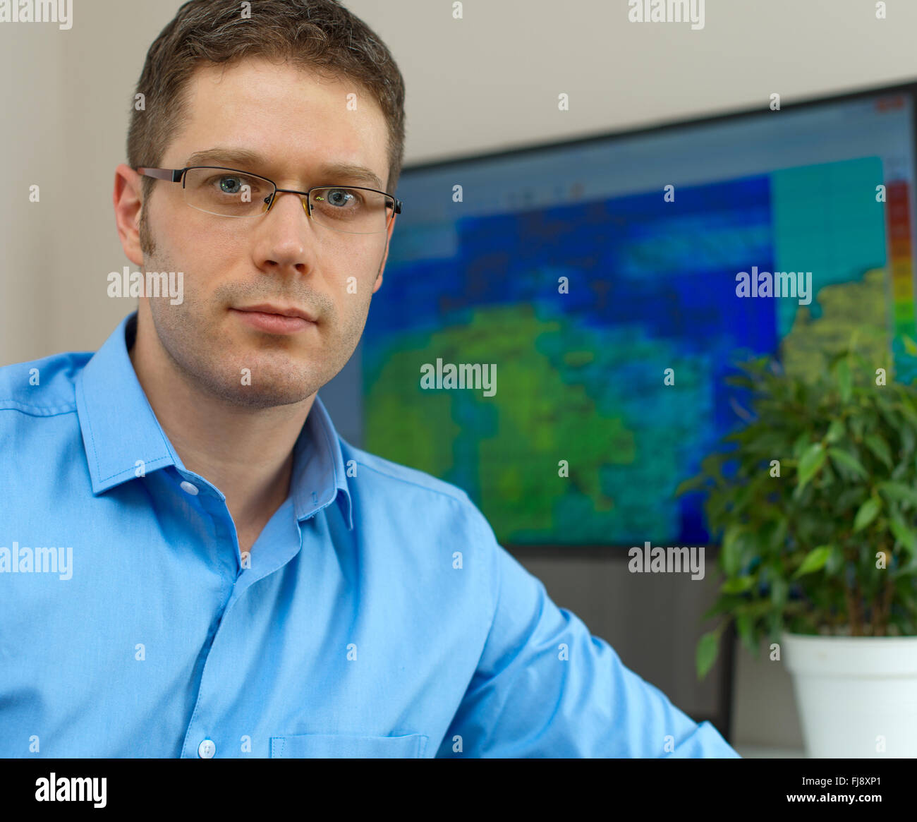 Handsome male meteorologist in glasses on his workplace Stock Photo - Alamy