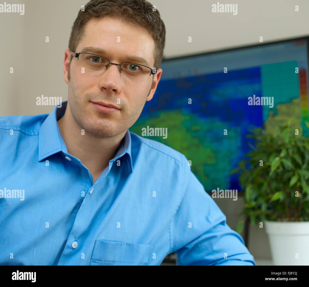 Handsome male meteorologist in glasses on his workplace Stock Photo - Alamy