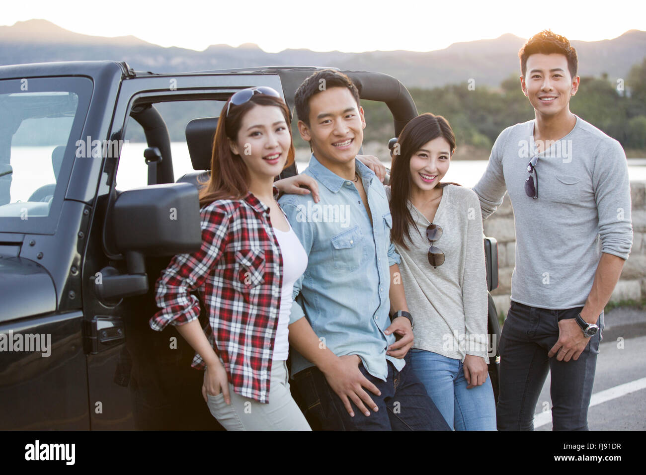 Happy Chinese friends and jeep Stock Photo - Alamy