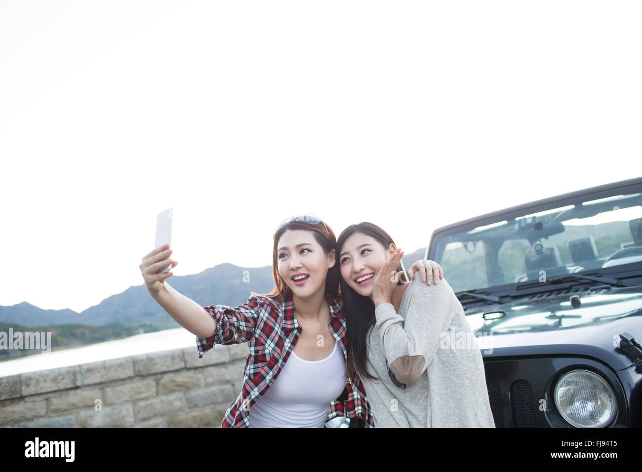 Young Chinese women taking self portrait with smart phone Stock Photo ...