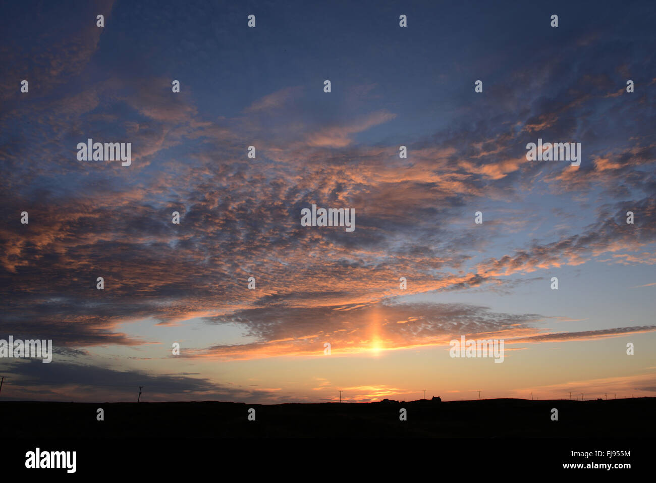 Unusual sun pillar at sunset on South Uist, Outer Hebrides, Scotland ...
