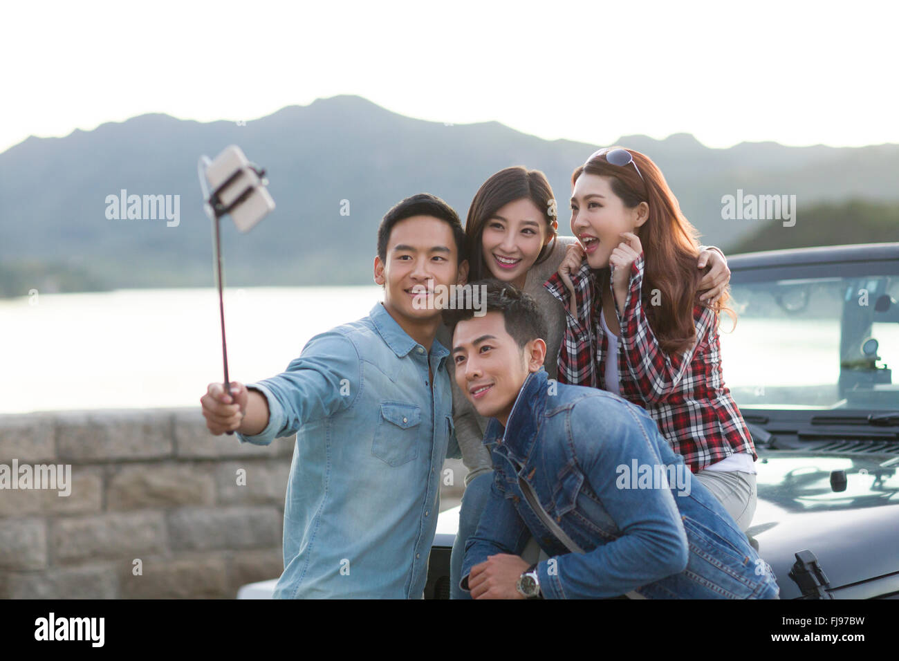 Happy Chinese friends taking self portrait with smart phone Stock Photo ...