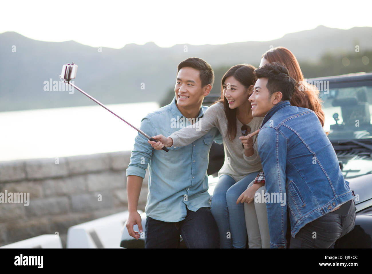Happy Chinese friends taking self portrait with smart phone Stock Photo ...