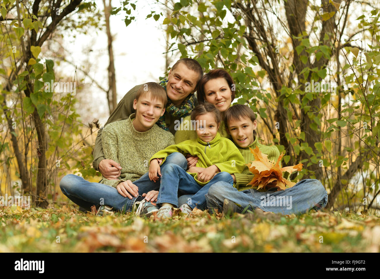 Family in autumn park Stock Photo - Alamy