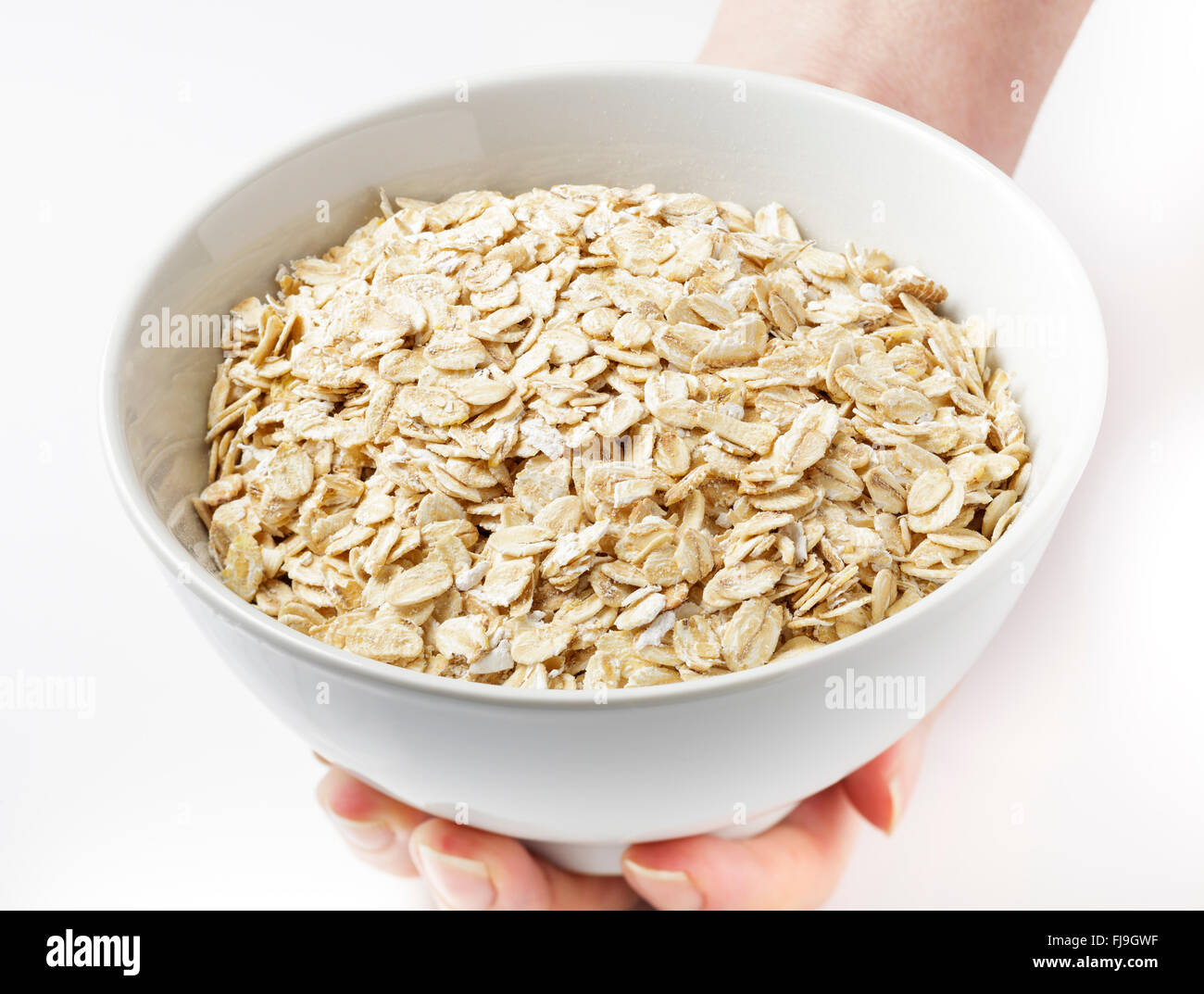 hand holding bowl of oats Stock Photo - Alamy