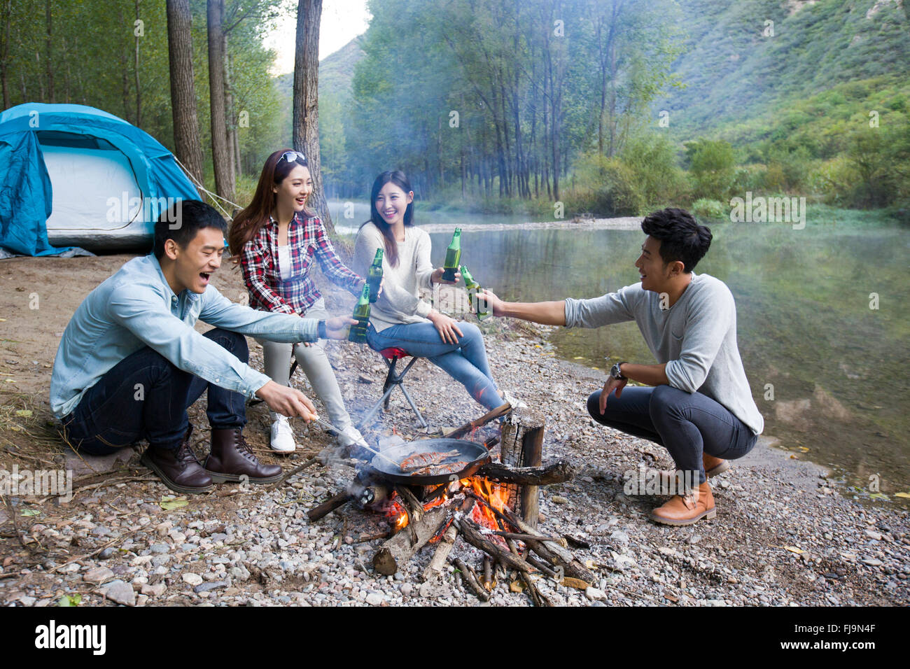 People around campfire talking hi-res stock photography and images - Alamy