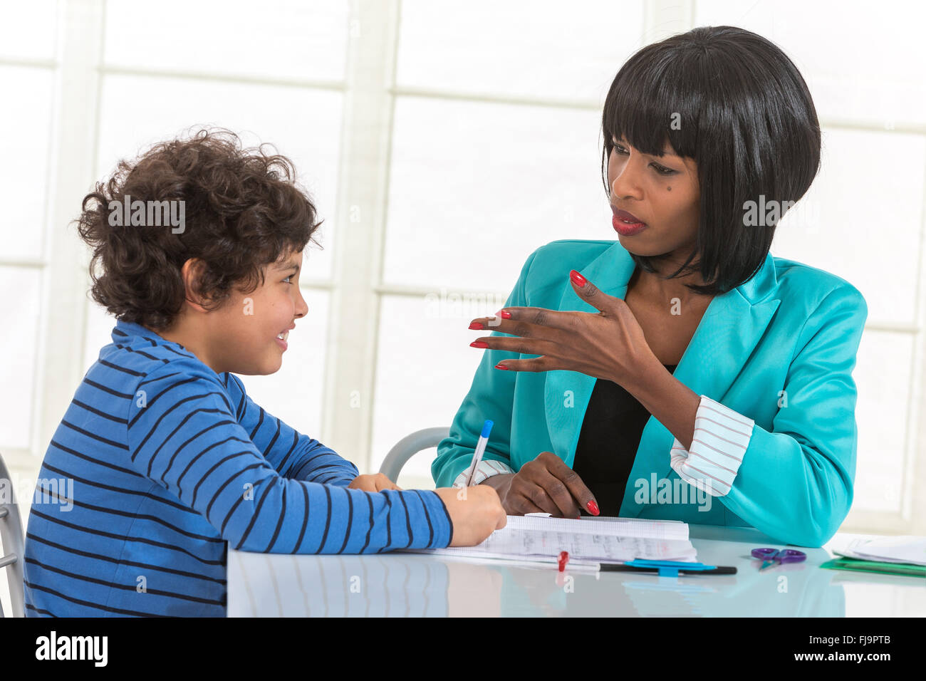 Portrait of mom helping son with homework Stock Photo - Alamy