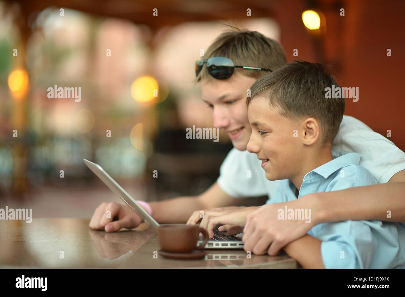 brothers with laptop Stock Photo - Alamy
