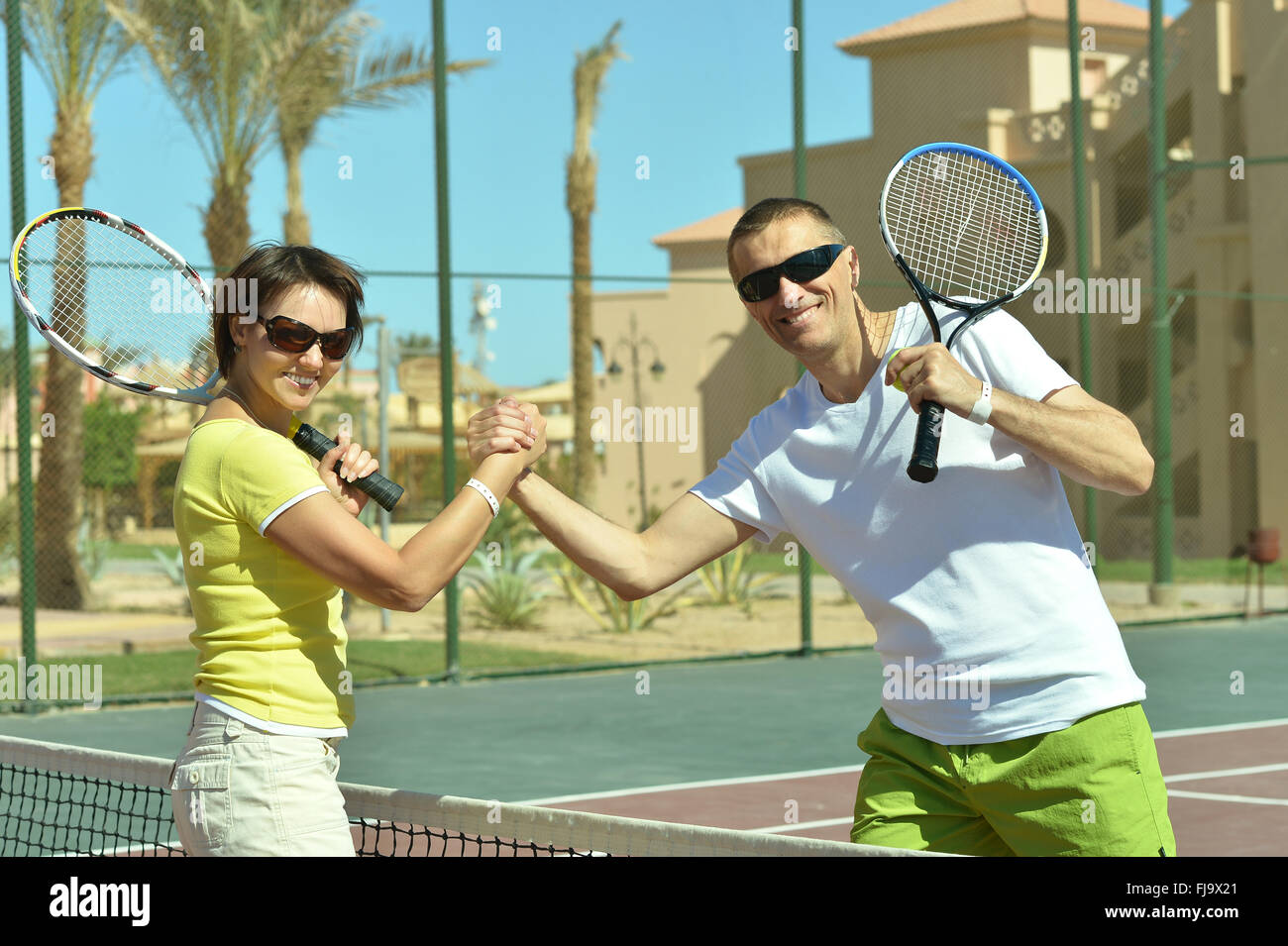 Tennis players standing near net Stock Photo - Alamy