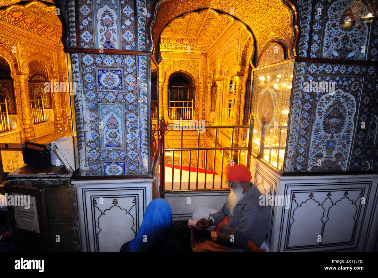 Old man reading holy book, golden temple, amritsar, punjab, india, asia ...