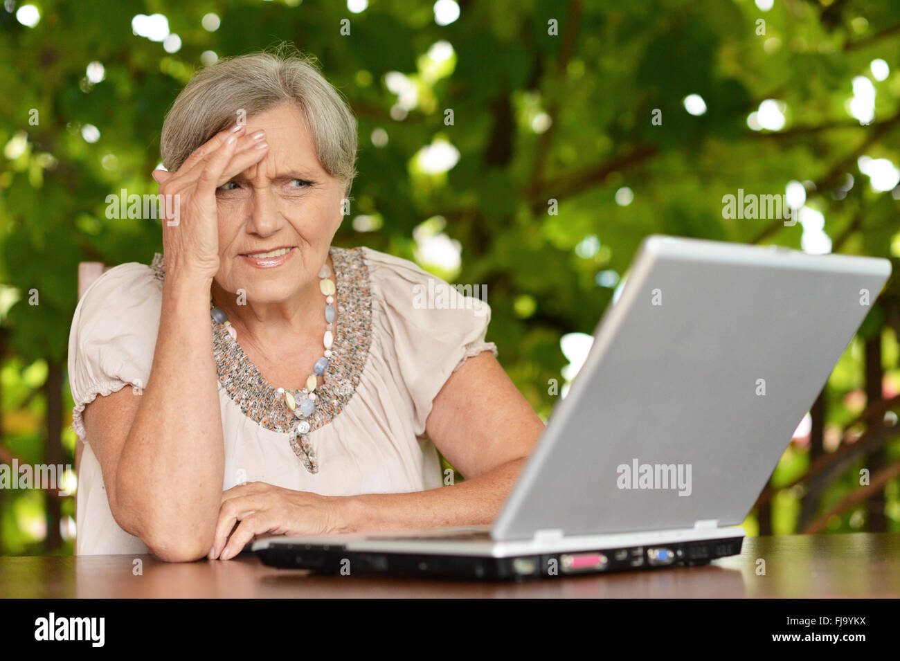 Older woman with laptop Stock Photo - Alamy