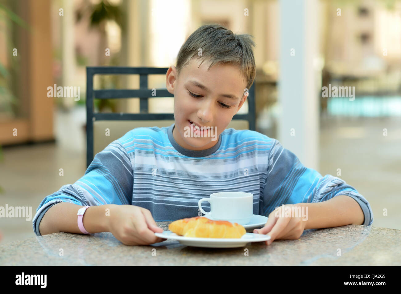 Happy boy at breakfast Stock Photo - Alamy