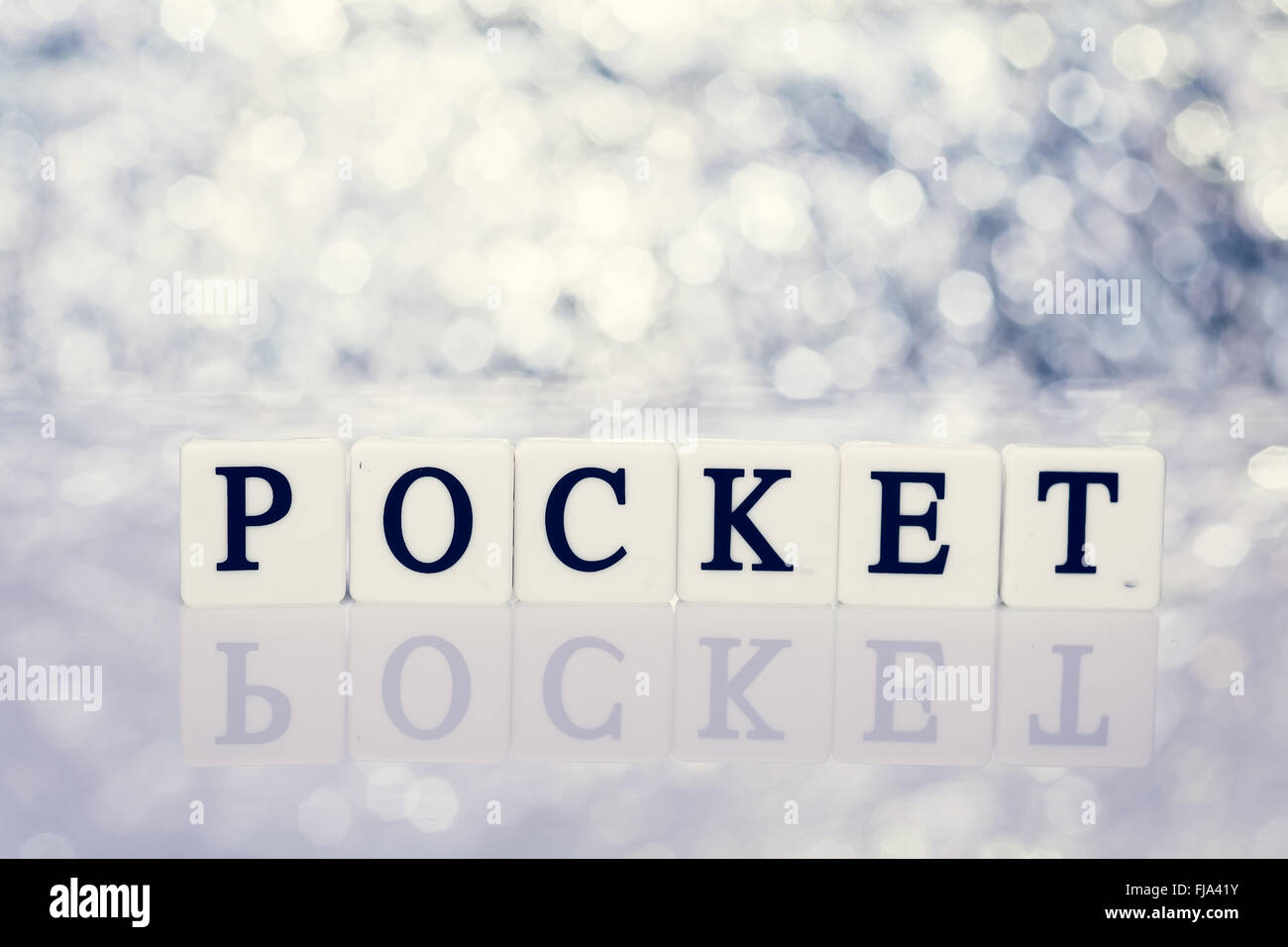 Written word of tiles with letters - pocket Stock Photo - Alamy