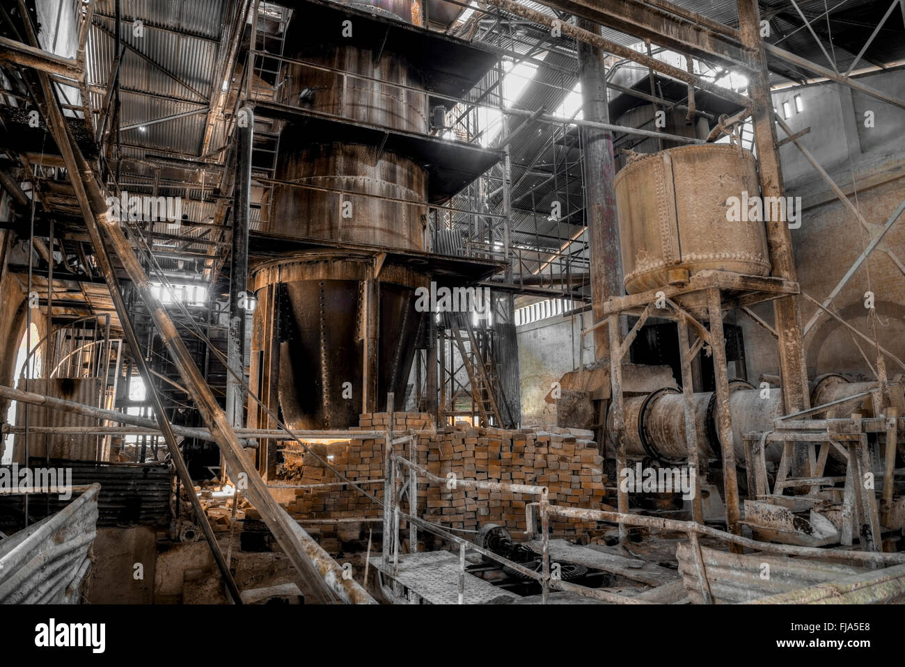 Old rusty colonial style factory for grinding limestone Stock Photo - Alamy
