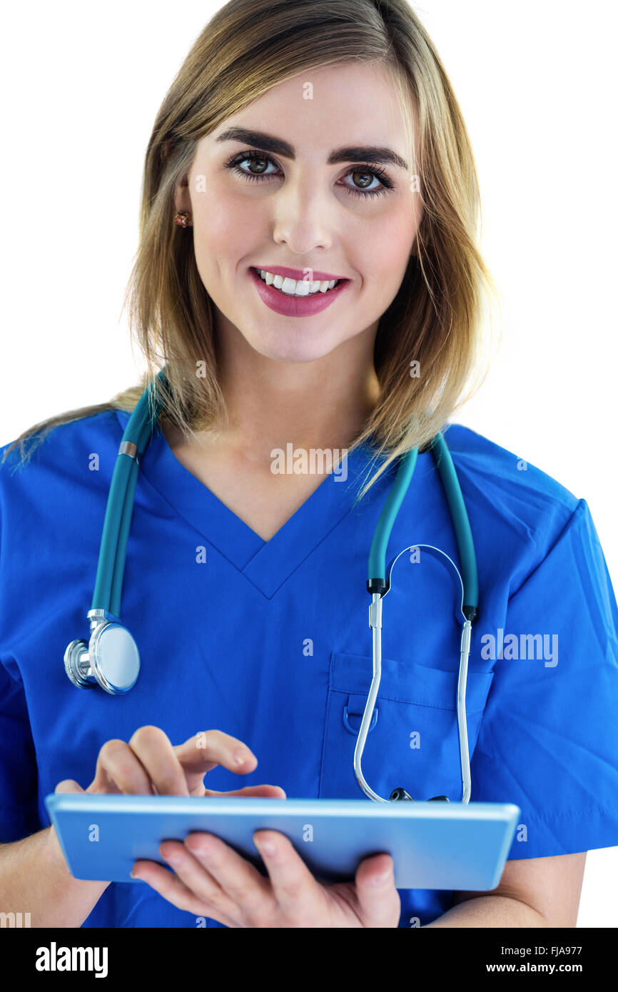 Smiling nurse using tablet Stock Photo - Alamy