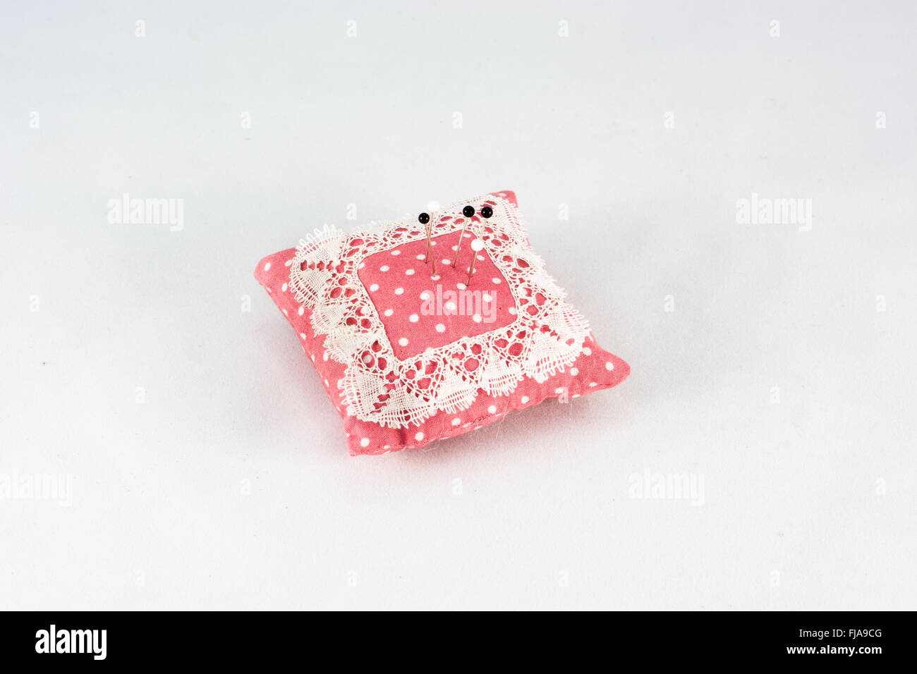 Pink pin cushion with lace on it Stock Photo - Alamy