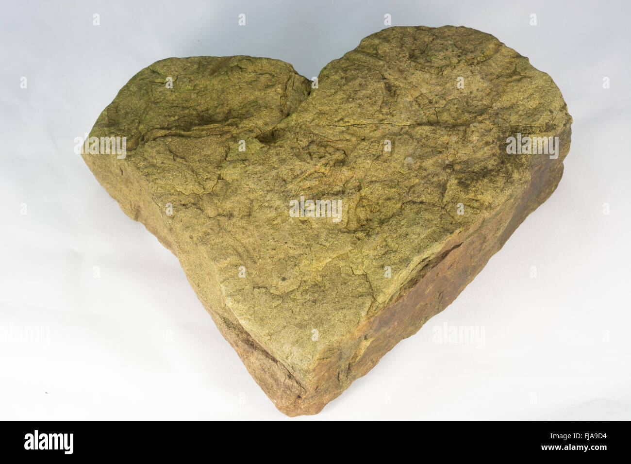 Stone heart on a white background Stock Photo - Alamy