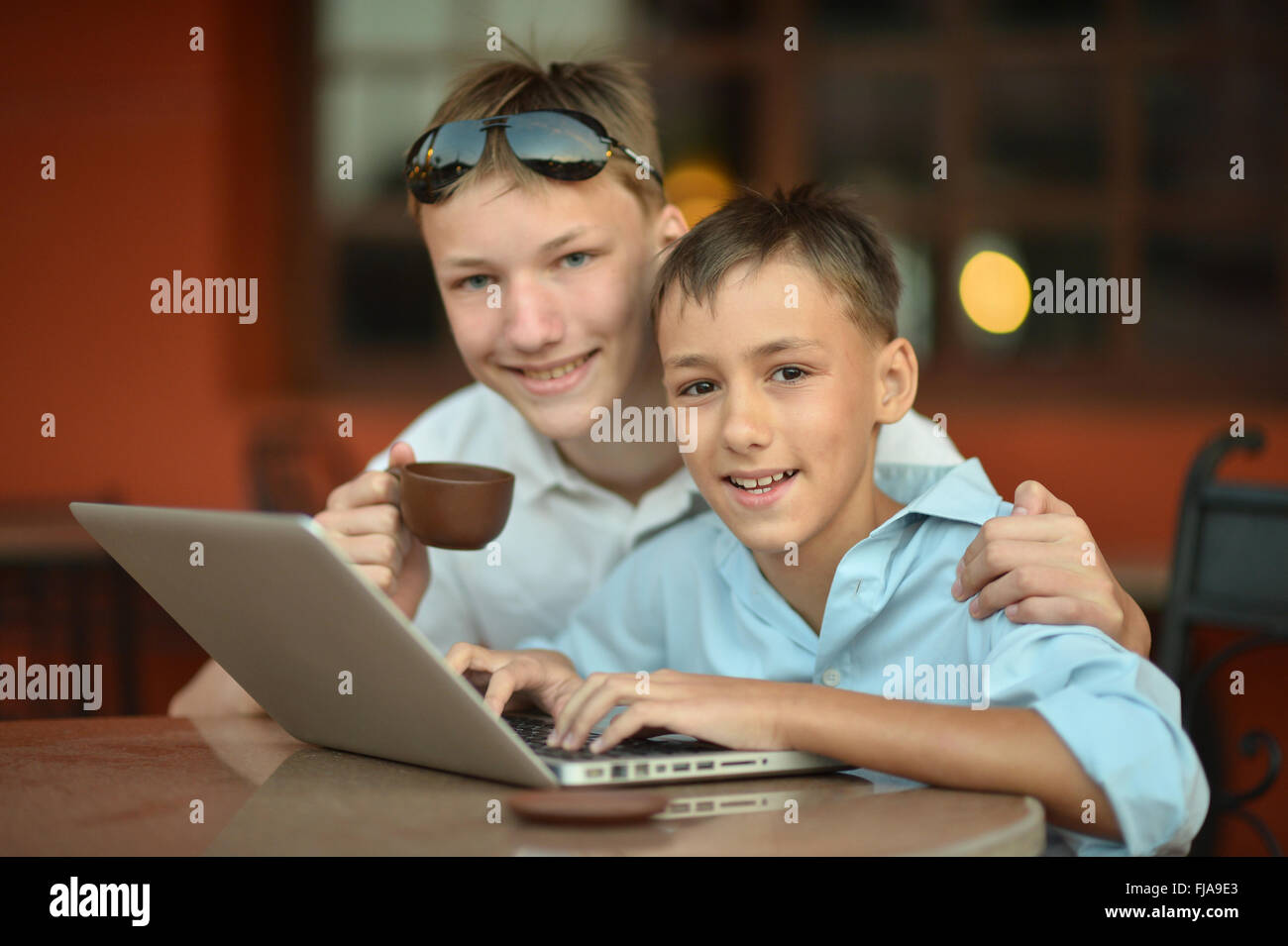 brothers with laptop Stock Photo - Alamy